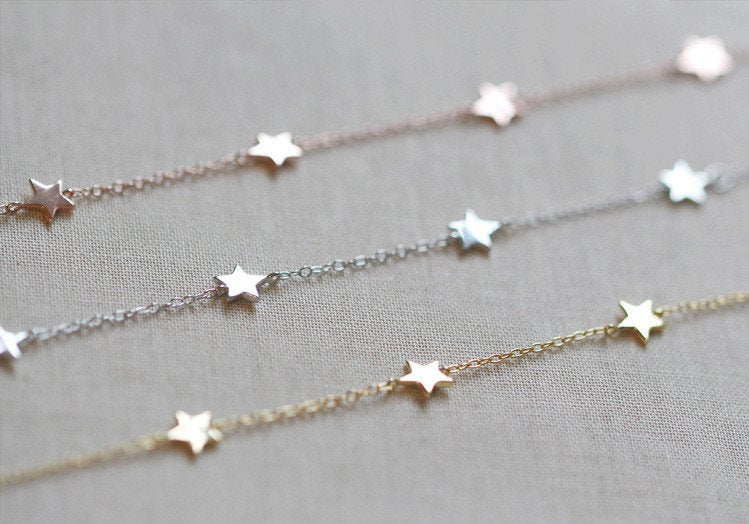 Six tiny little stars hang alongdelicate chain. Works great layered wi ...